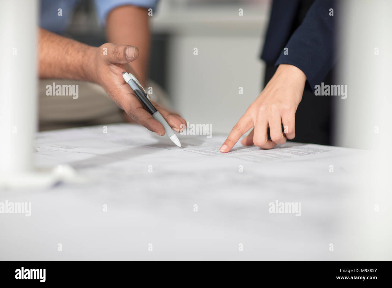Close-up of colleagues in office discussing plan Stock Photo - Alamy