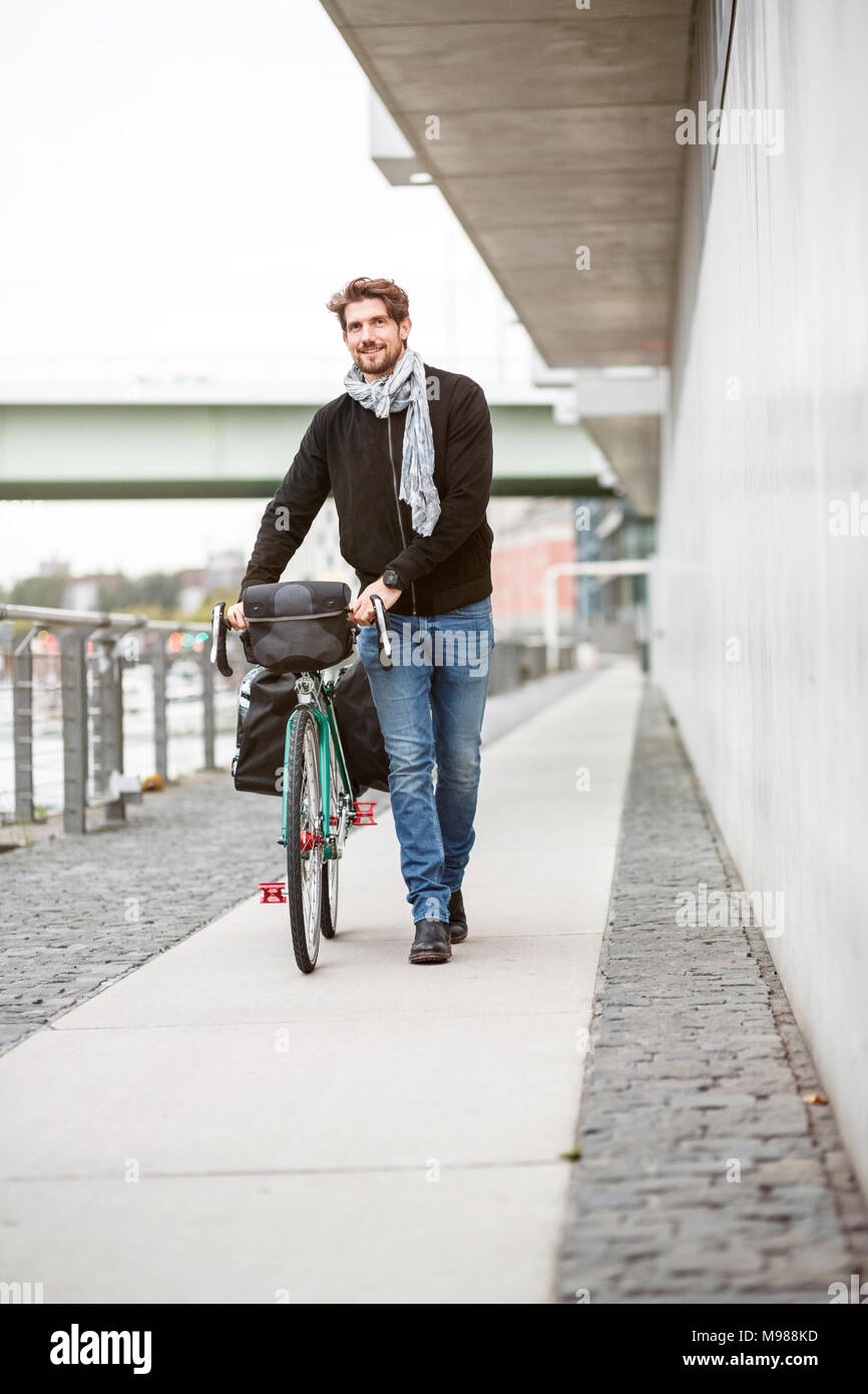 Man pushing a bicycle hi-res stock photography and images - Alamy