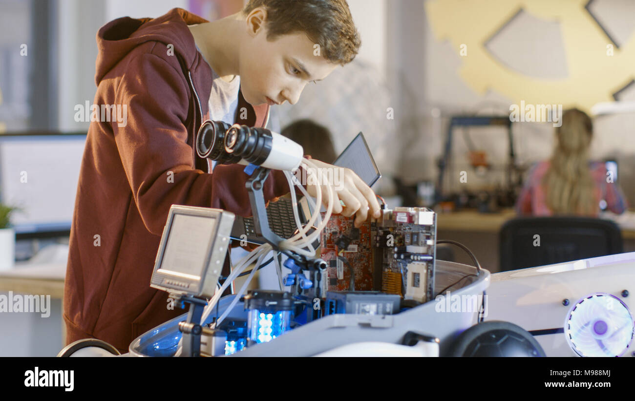 Boy Works on a Fully Functional Programable Robot with Bright LED ...
