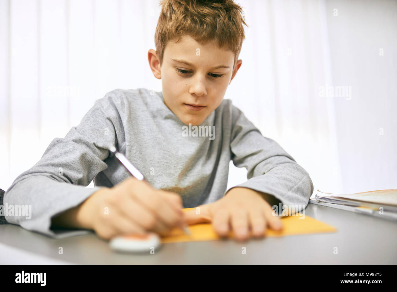Schoolboy writing desk in classroom hi-res stock photography and images ...