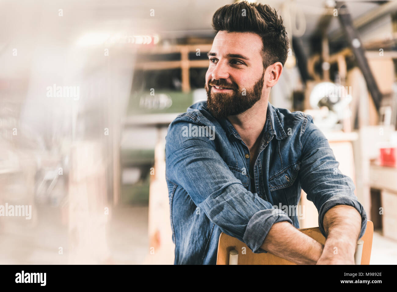 Smiling man sitting on chair people hi-res stock photography and images ...