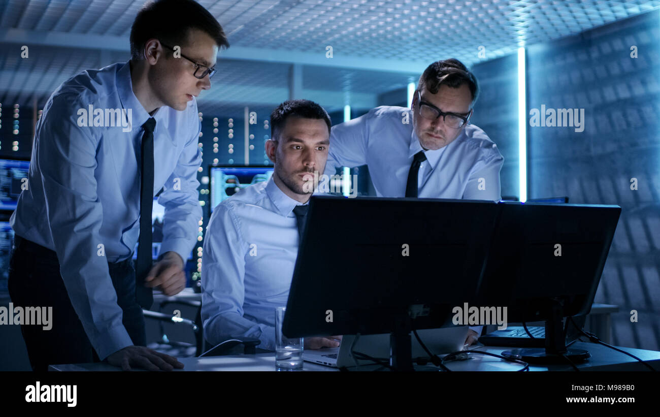 Three Operations Engineers Solving Problem in a Monitoring Room. In ...