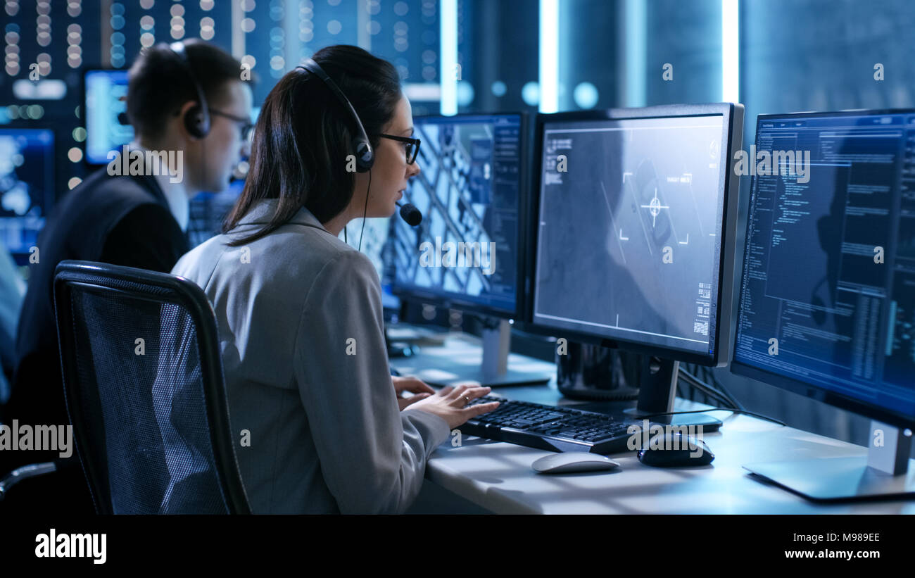 Female working in a Surveillance Team Gives Instructions with the Help ...