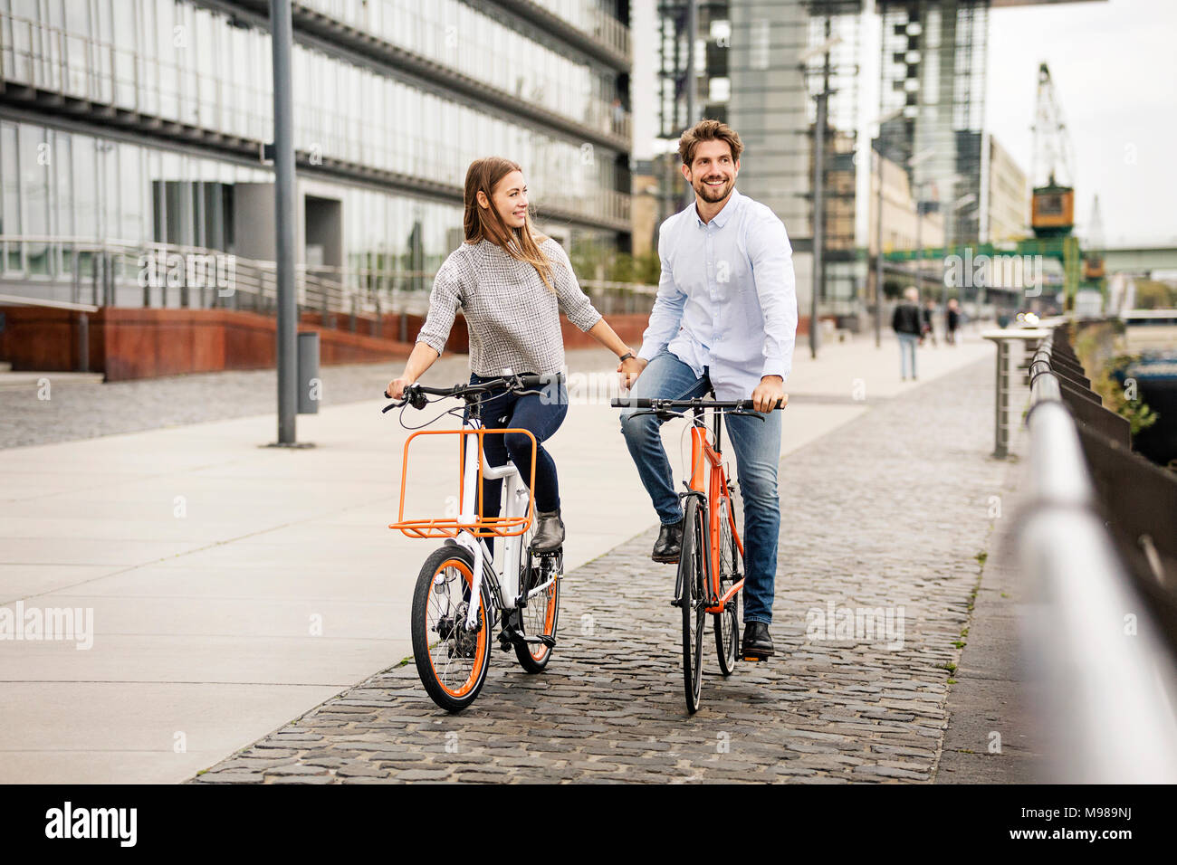 Joyful couple riding bicycle hi-res stock photography and images - Alamy