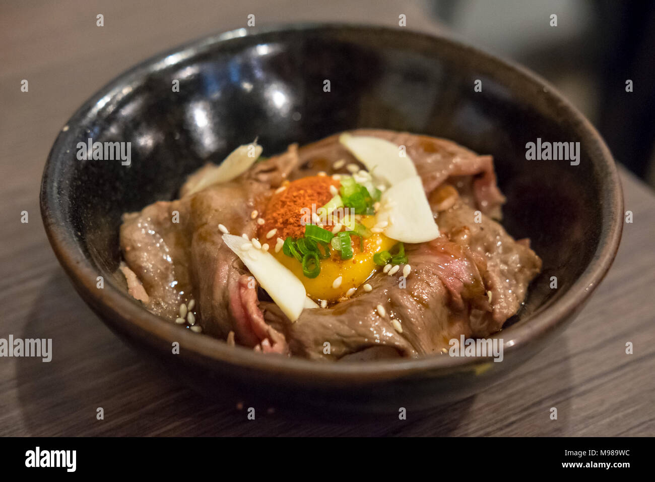 Gyudon, a Japanese dish consisting of a bowl of rice topped with rare ...