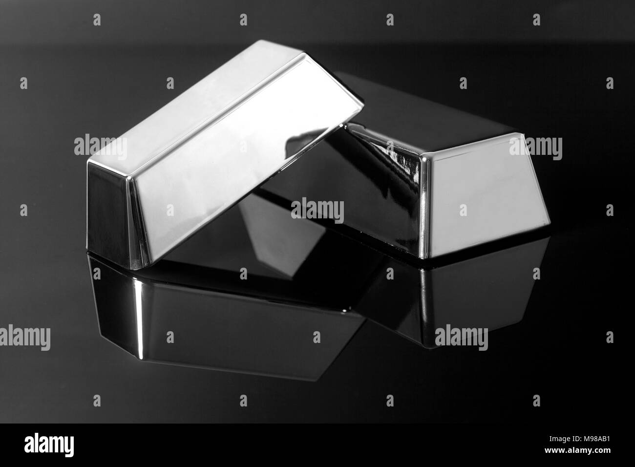 Silver bullion bars on a black background Stock Photo - Alamy