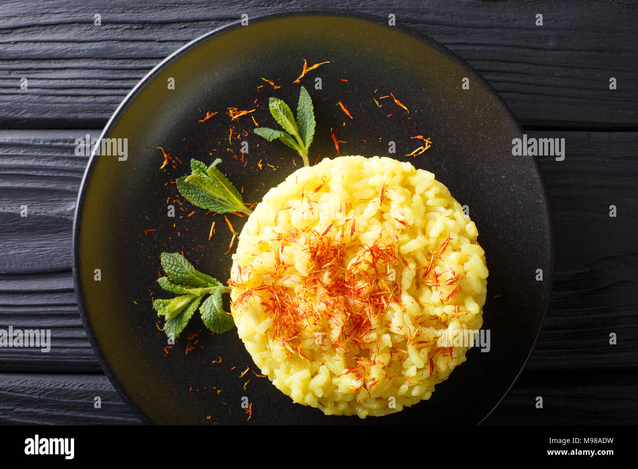 Italian risotto alla milanese with saffron closeup on a plate on a ...