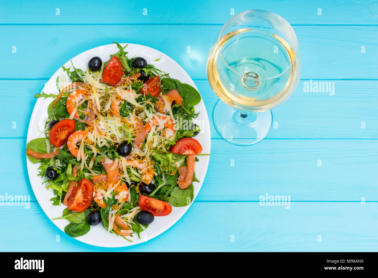 High angle view of appetizing salad with shrimps, grated cheese, mix of ...