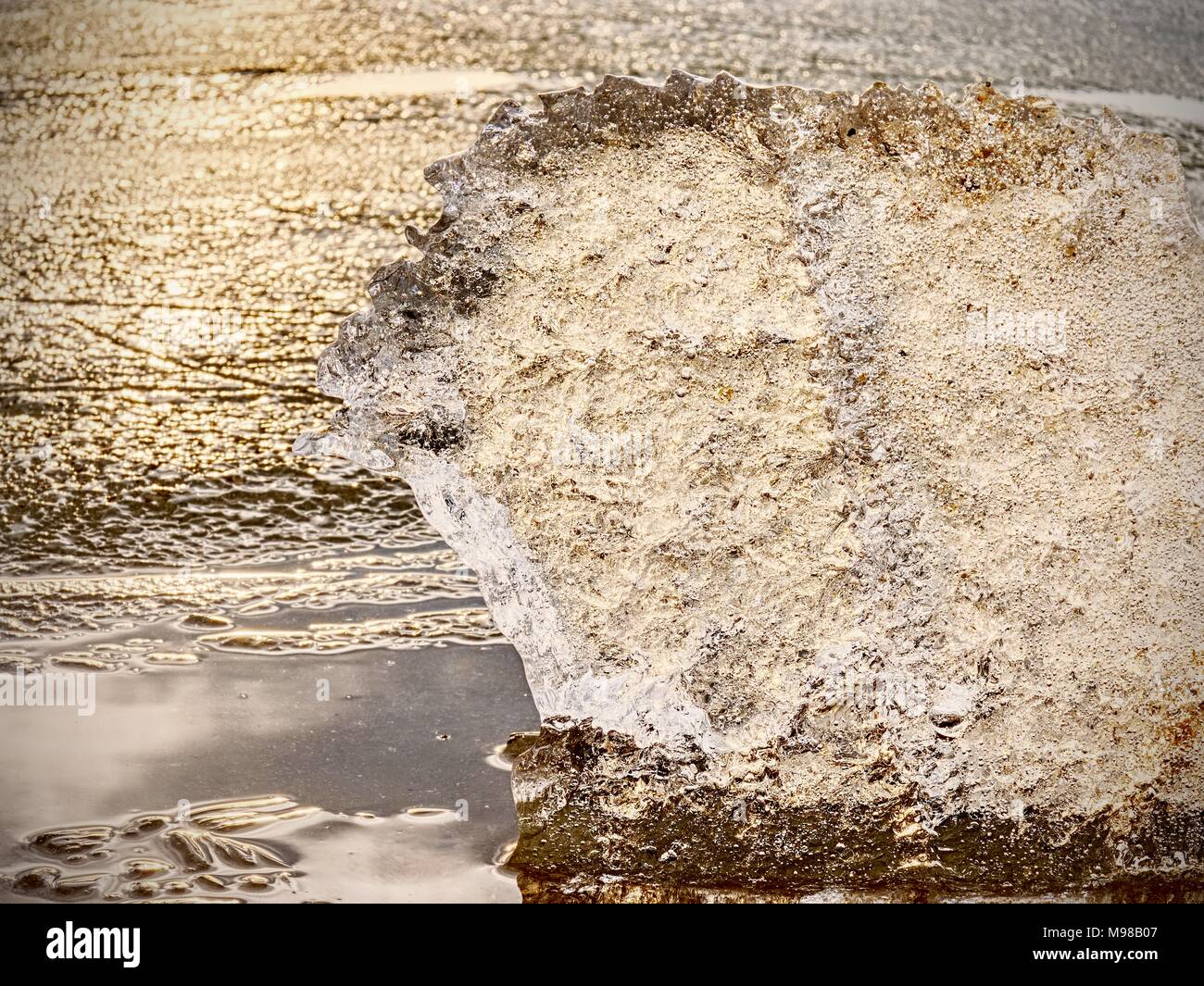 Ice piece in selective focus photo. Detail view into deep clefts and ...