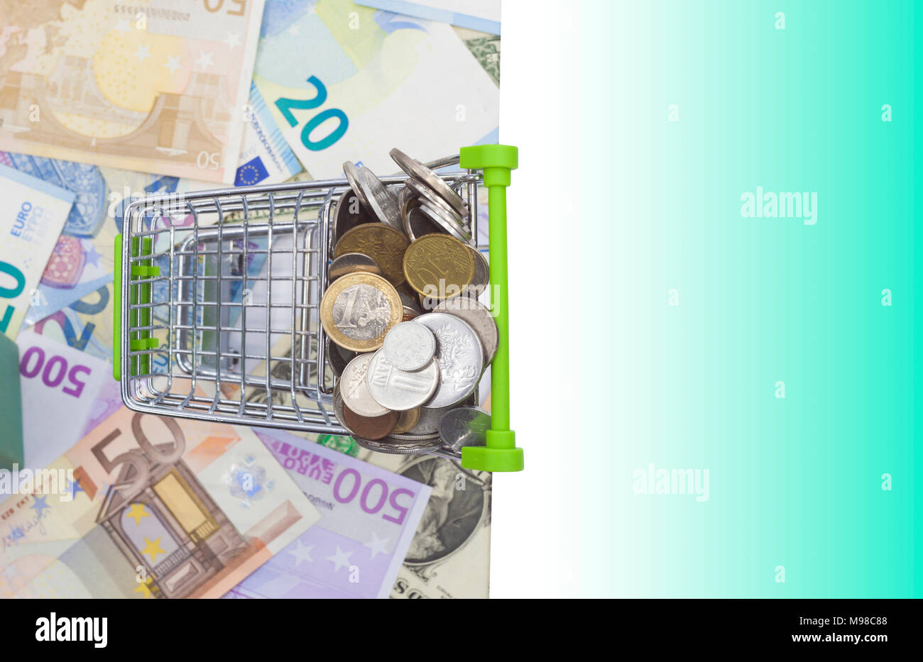 shopping cart with coins and banknotes in background. white board for ...