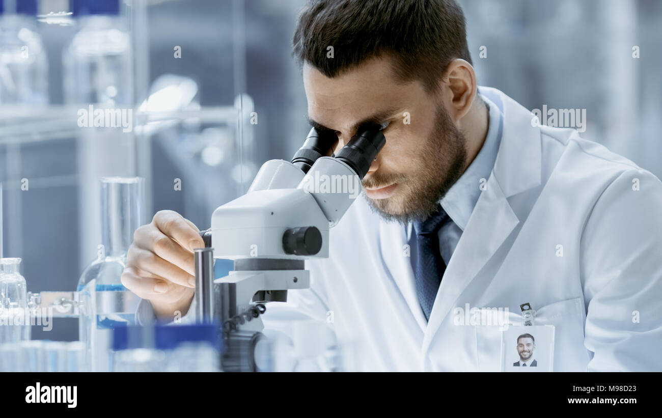 Close-up Shot of Research Scientist Adjusts His Microscope. He's ...
