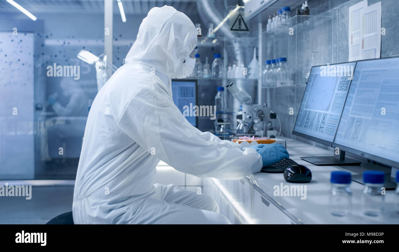 In a Secure High Level Laboratory Scientists in a Coverall Conducting a ...
