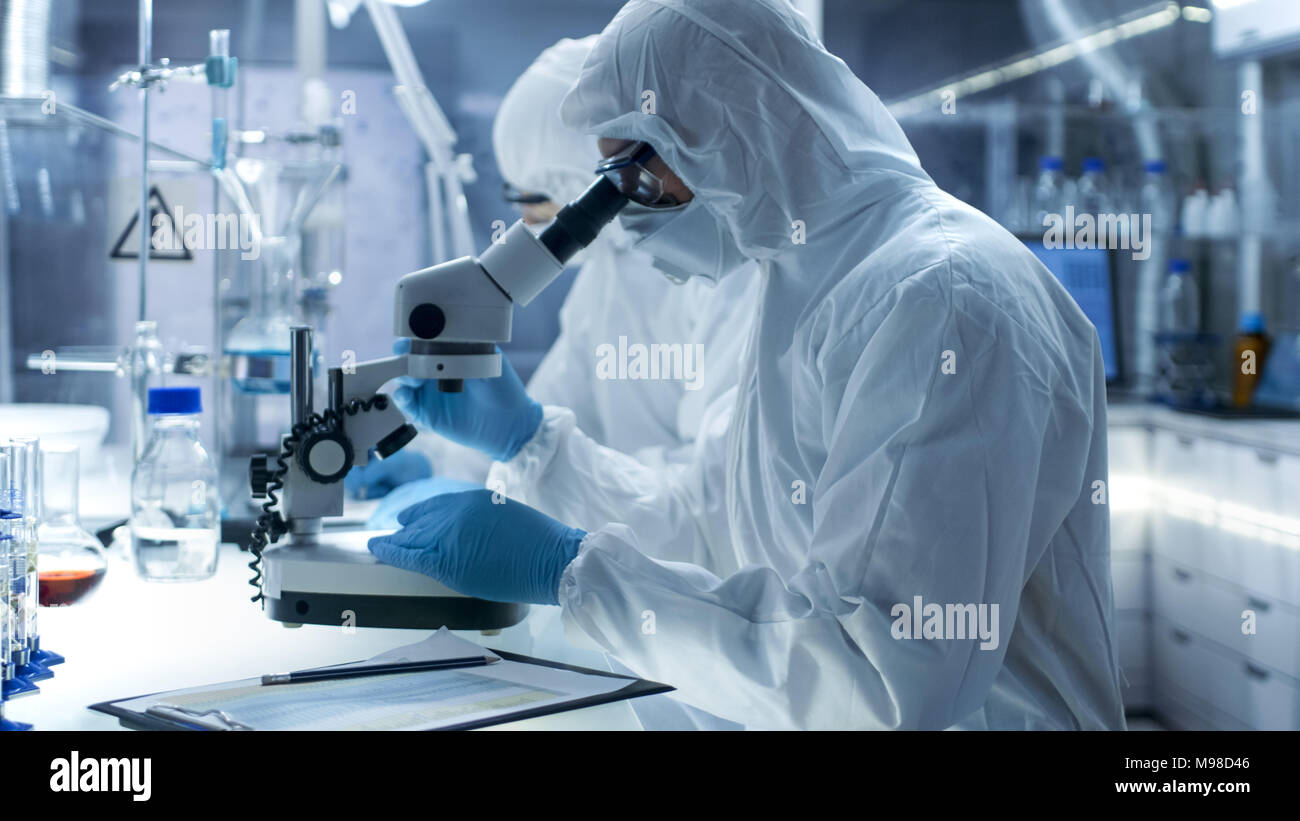 In a Secure High Level Laboratory Scientists in a Coverall Conducting a ...
