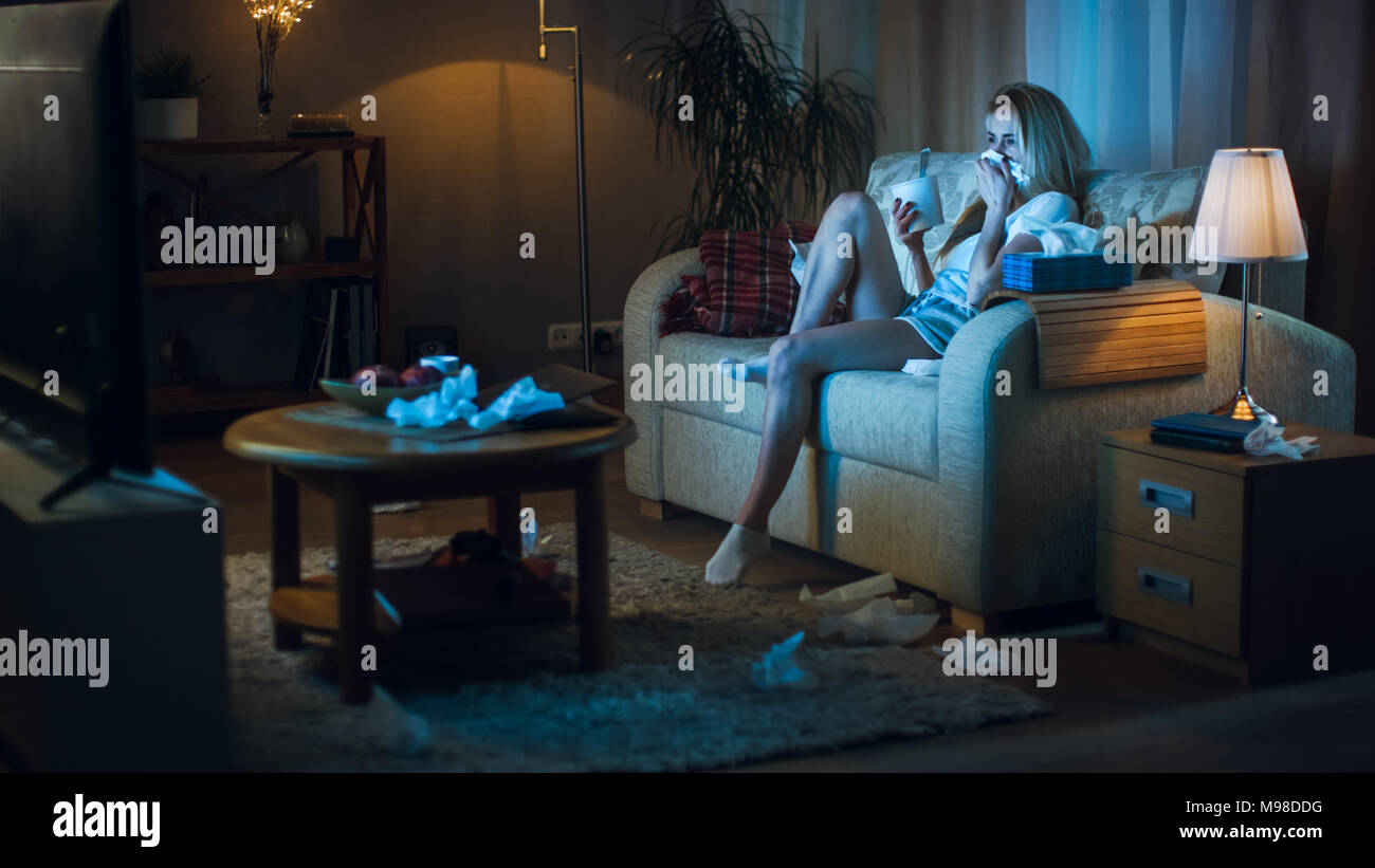 In the Evening Heartbroken Girl Sitting on a Sofa, Crying, Using ...