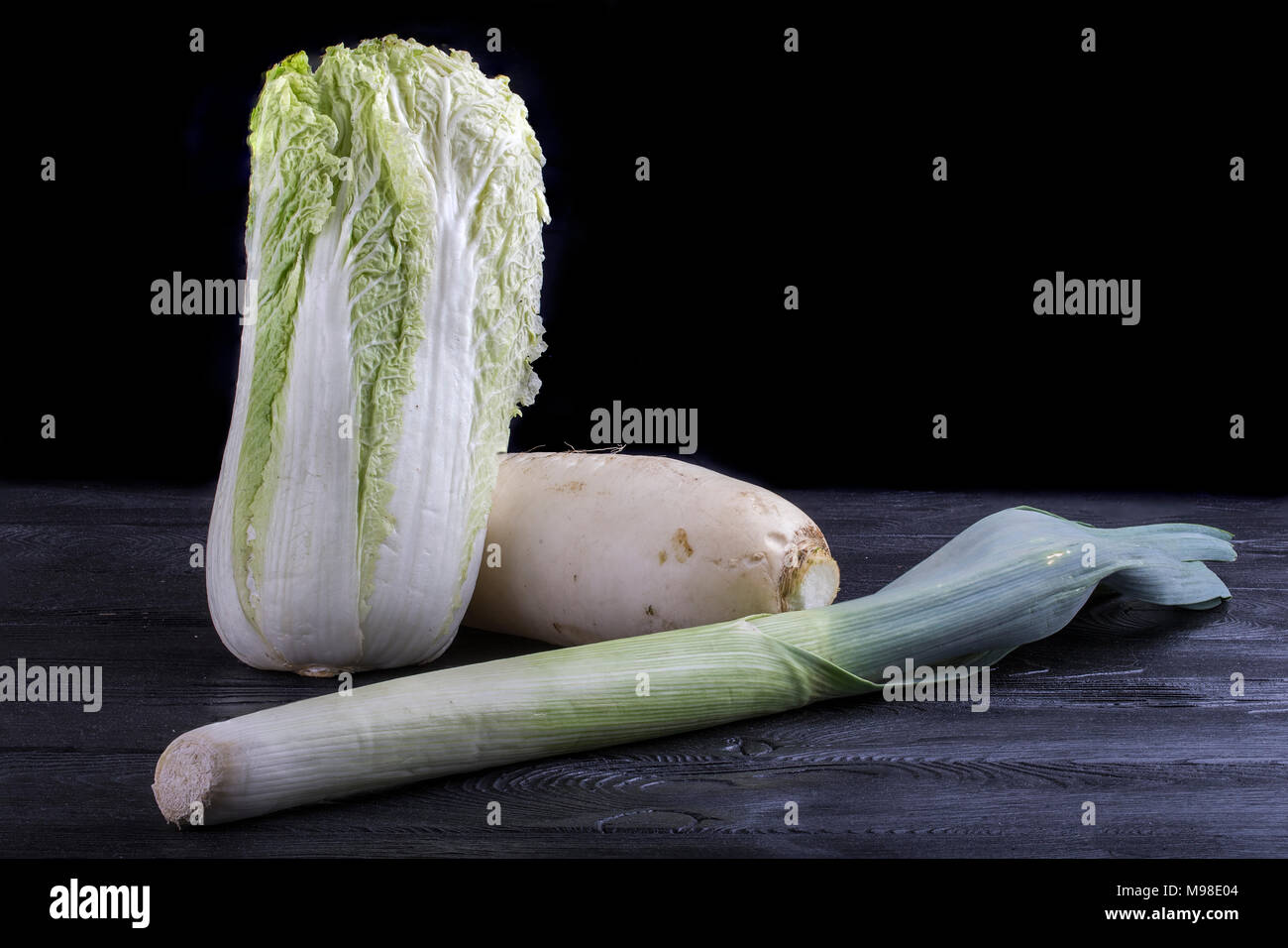 Raw unwashed vegetables on a black wooden table. (Brassica rapa subsp ...