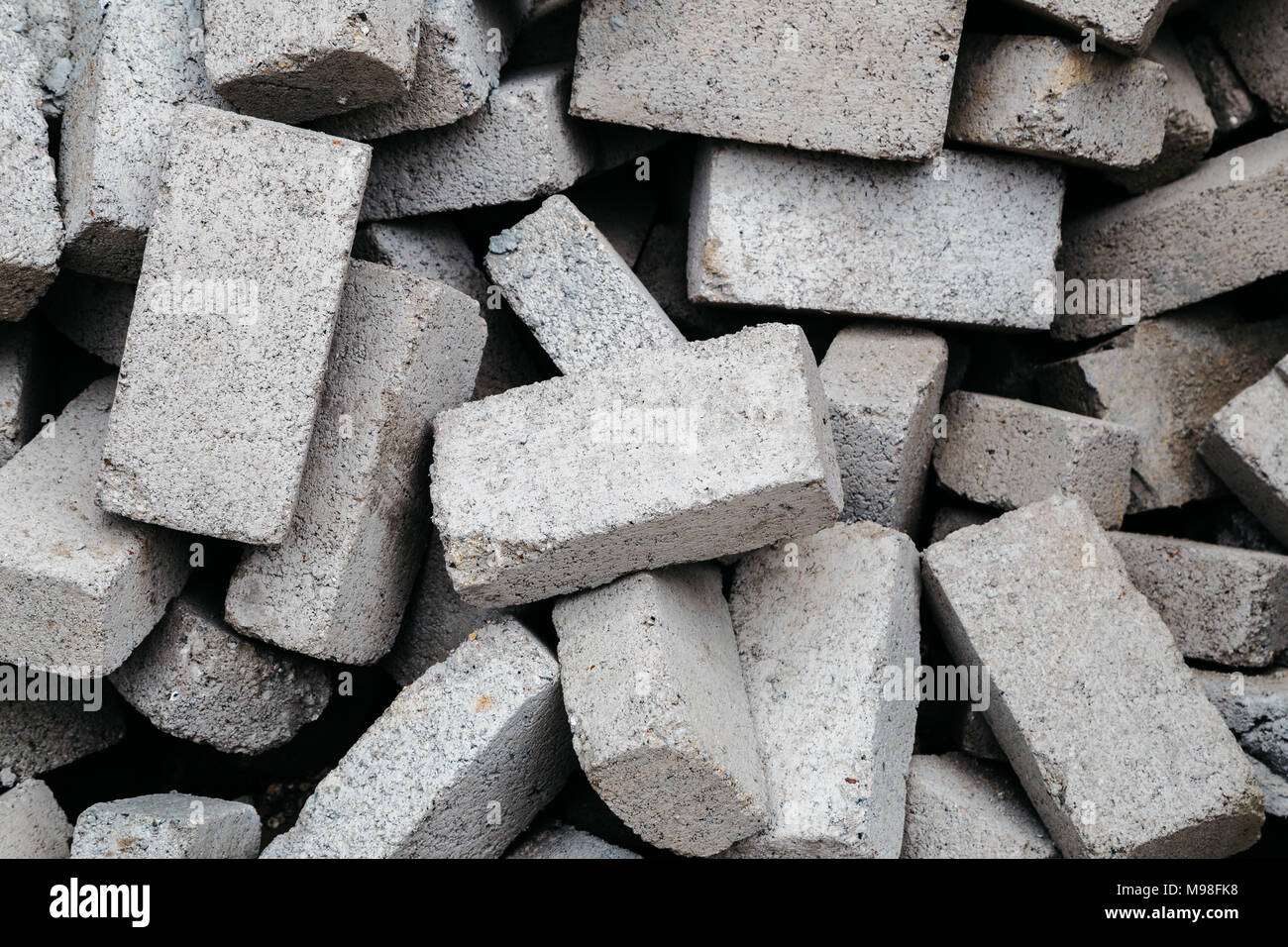 Stack of gray clay bricks for construction Stock Photo - Alamy