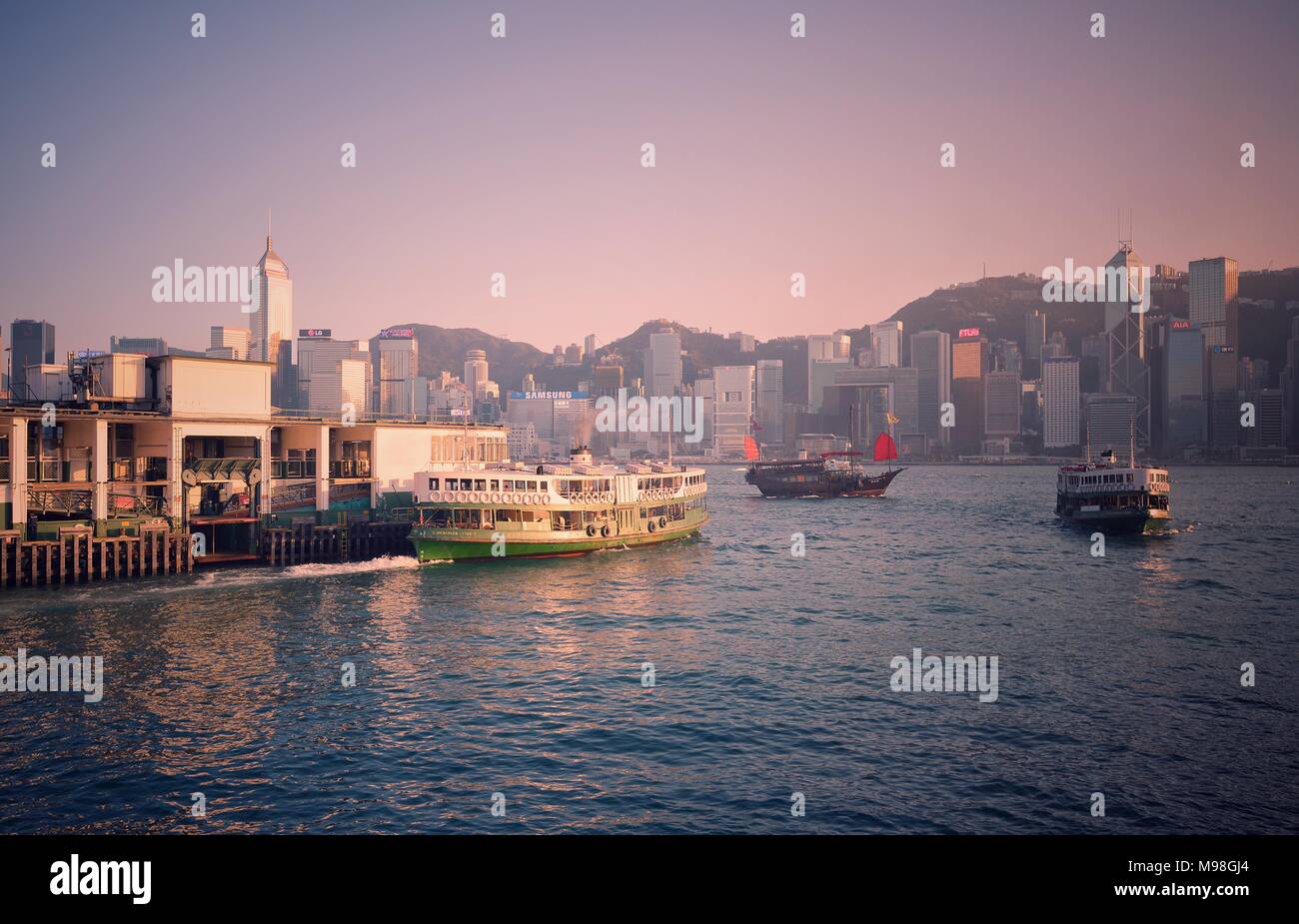 Victoria Harbour from TST. Star Ferry and Junk boat Stock Photo - Alamy