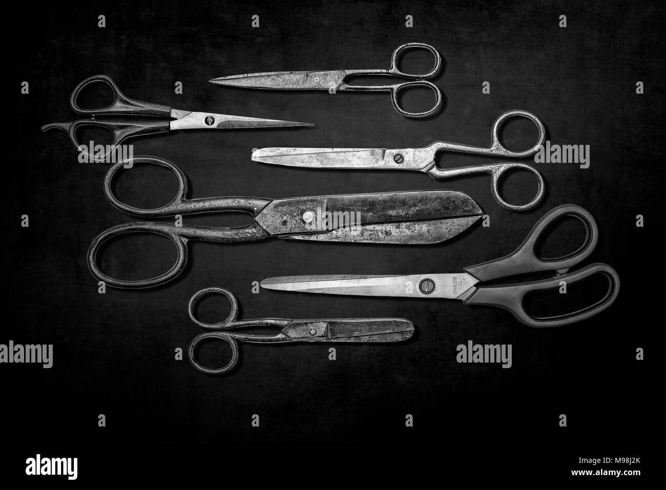 Group of various scissors isolated on dark background Stock Photo - Alamy