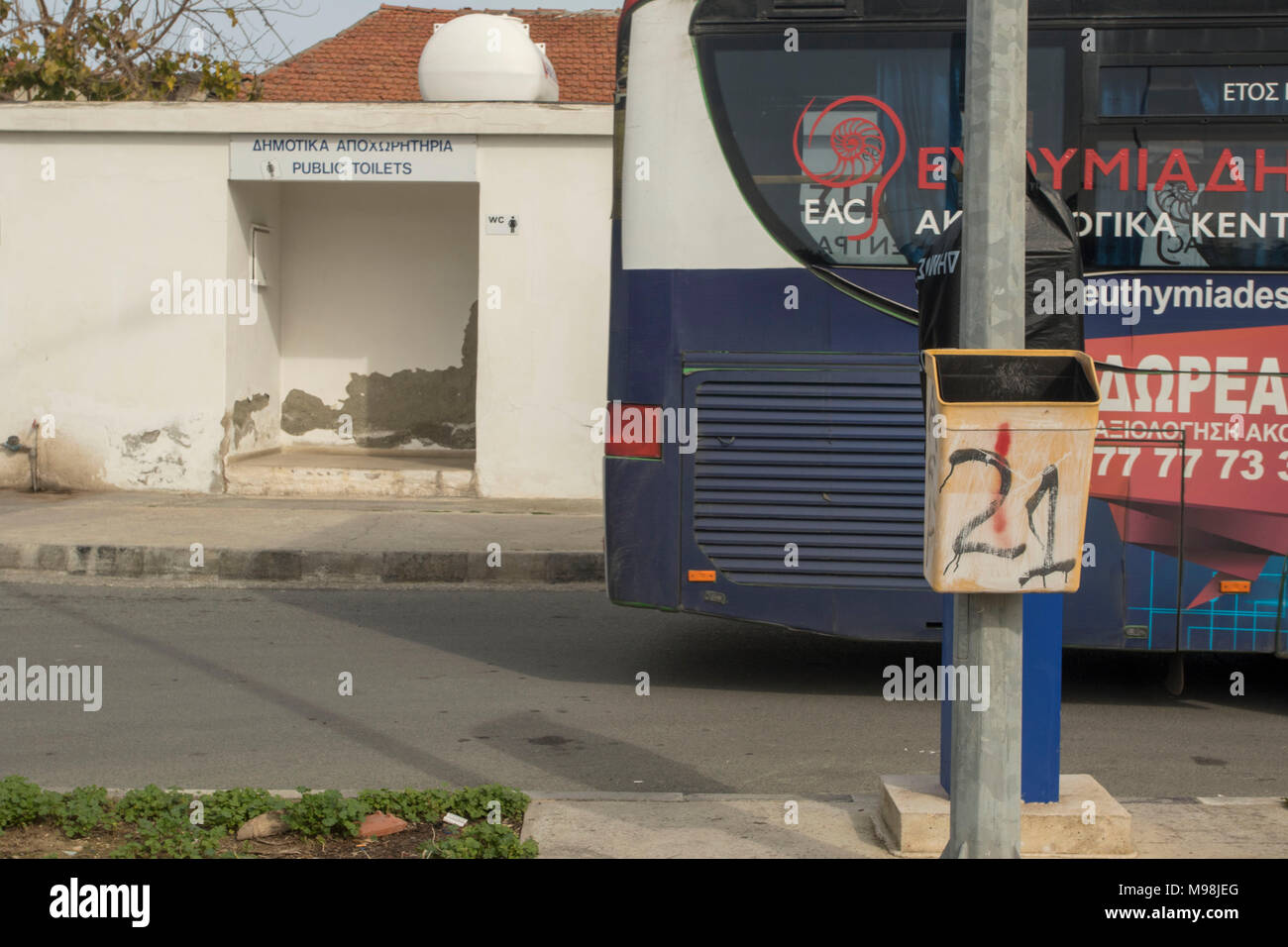 Public convenience building at Karavella bus station as bus turns and ...