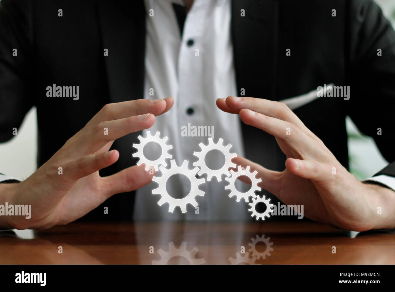 Integrated processes - hands protecting process chain Stock Photo - Alamy