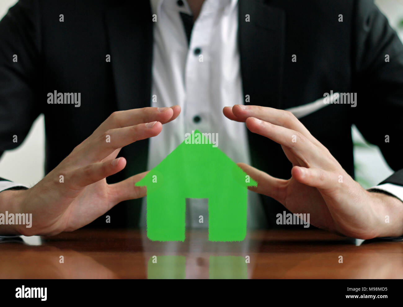 Hands protecting house hi-res stock photography and images - Alamy