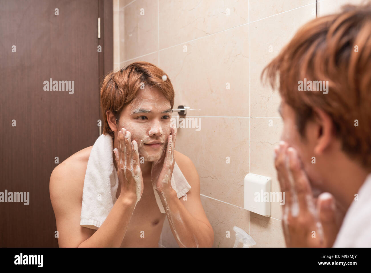 Portrait of an asian man washing in bathroom Stock Photo - Alamy