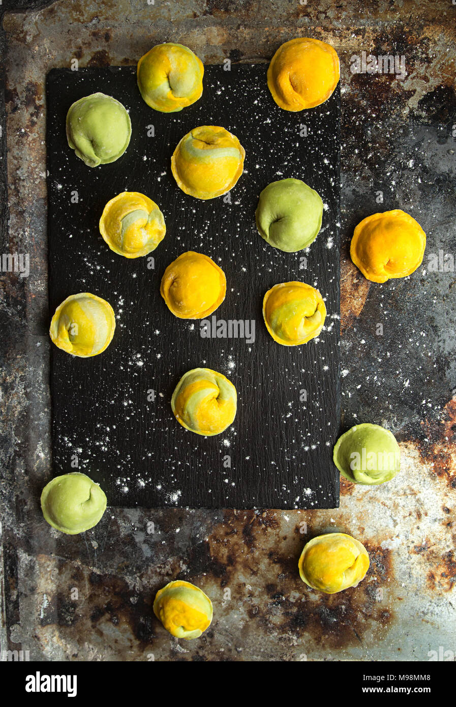 Homemade raw dumpling, yellow and green colors, traditional East ...