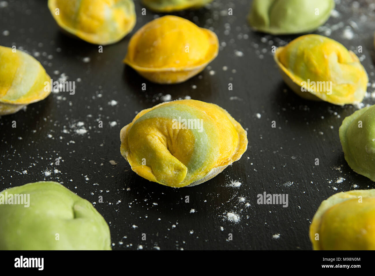 Homemade raw dumpling, yellow and green colors, traditional East ...