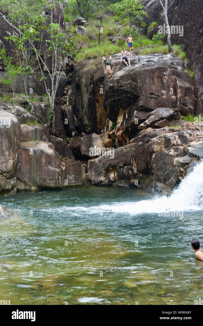 People jumping into a cool pool with a waterfall at the rockslides at ...