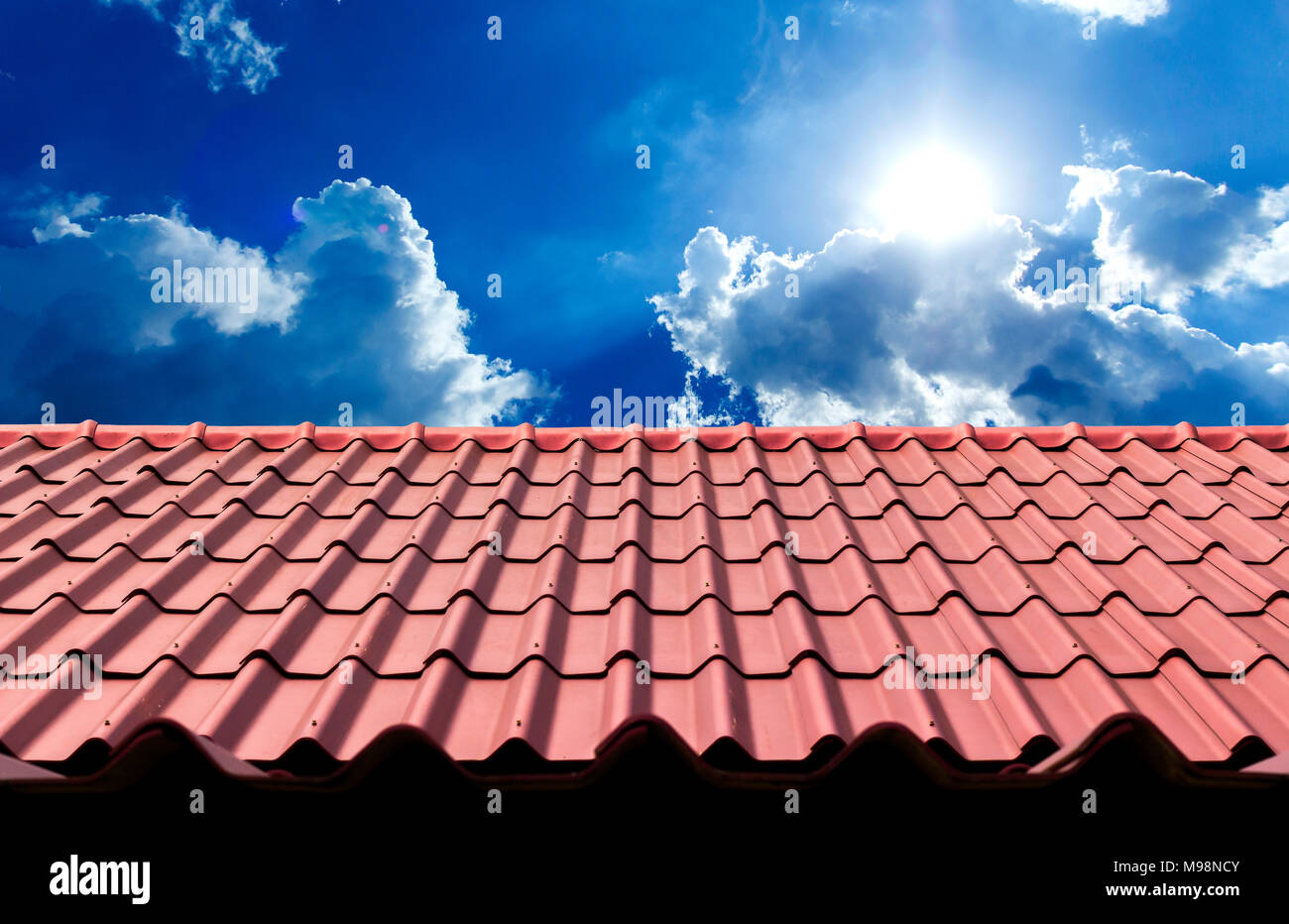 Roof with clouds and blue sky background Stock Photo - Alamy