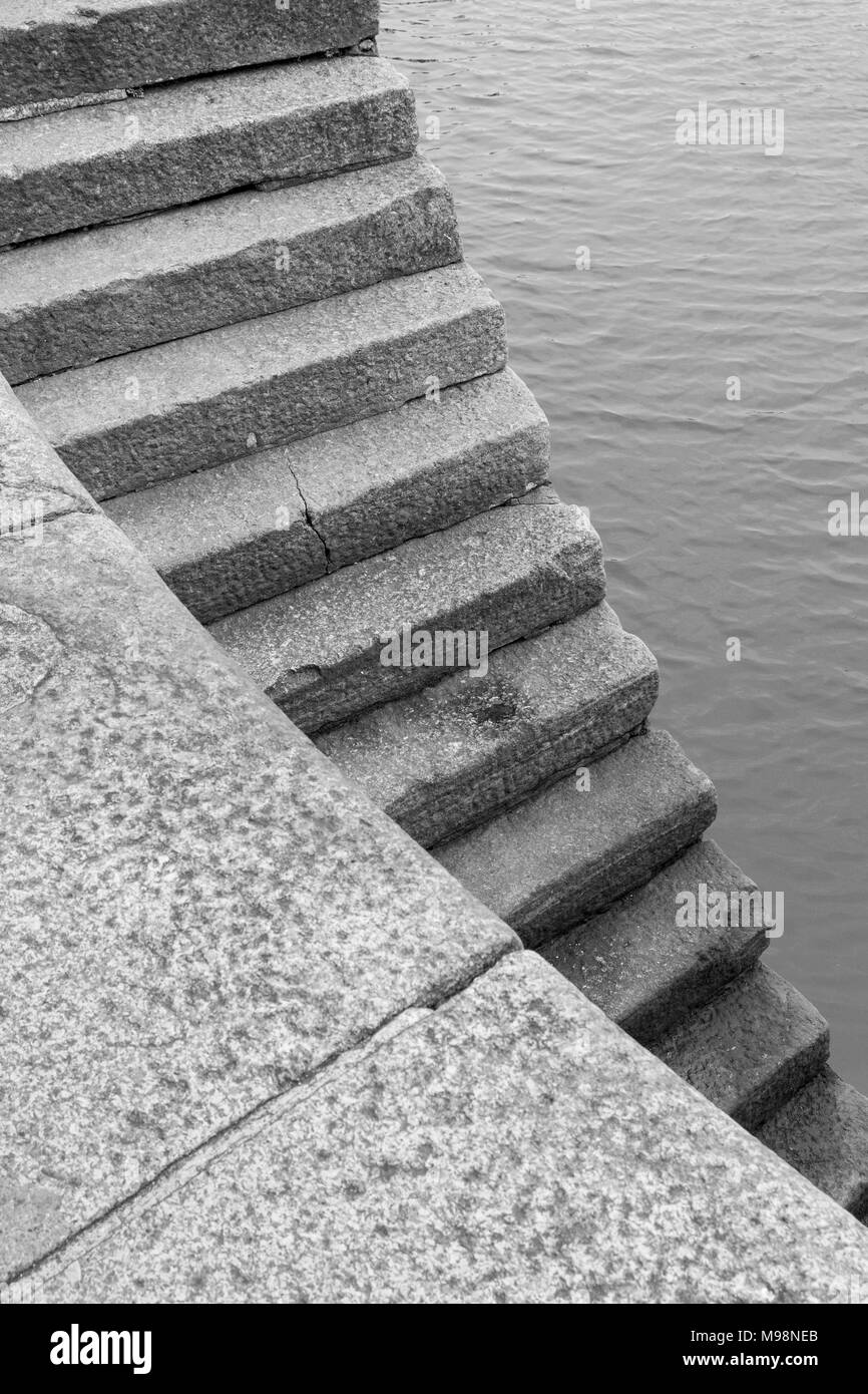 Stone steps leading down to harbour water in Plymouth, Devon. Metaphor ...