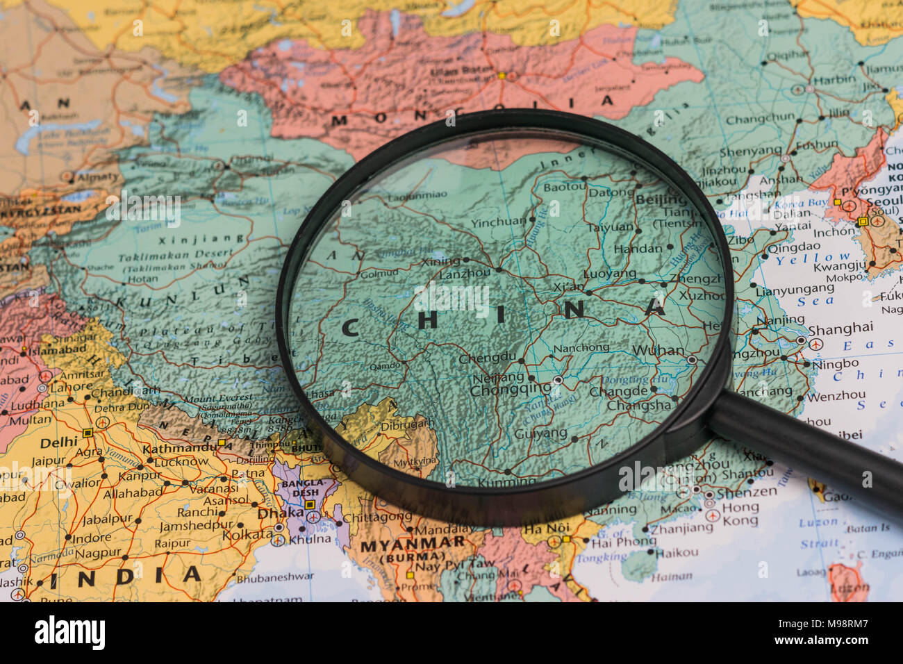Map of china through magnifying glass on a world map Stock Photo - Alamy