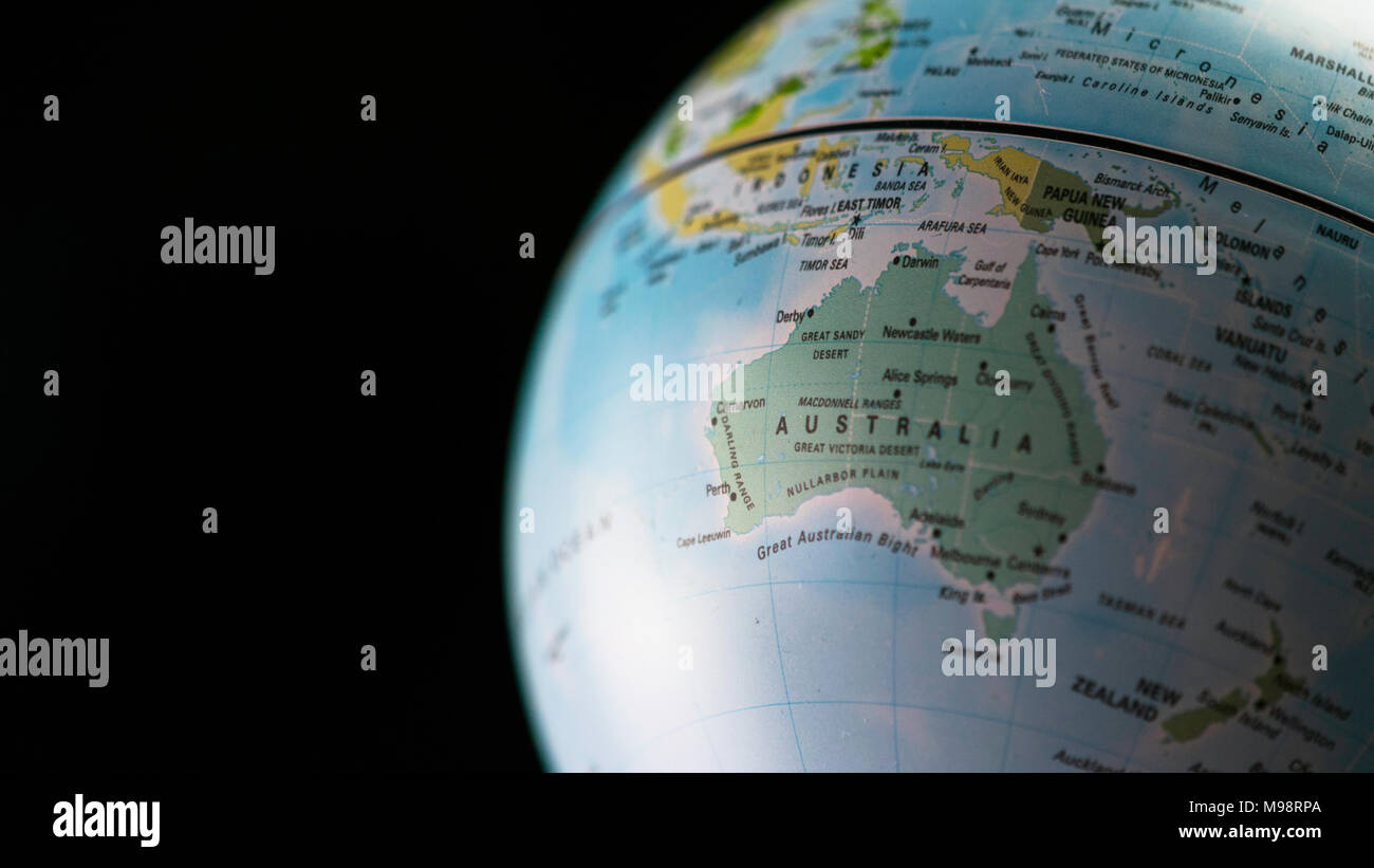Australia map on a globe with black background Stock Photo - Alamy