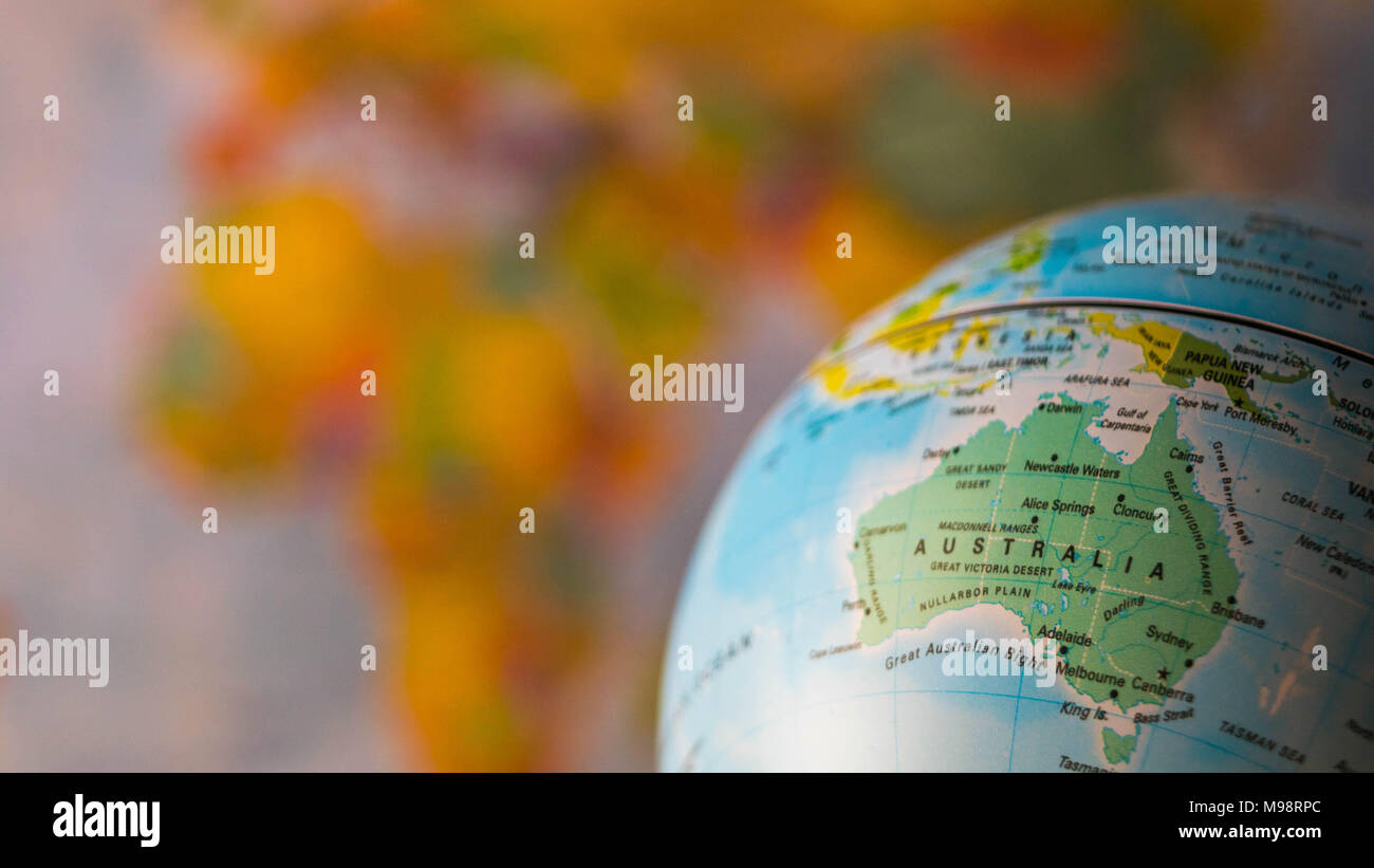 Australia map on a globe with earth map in the background Stock Photo ...