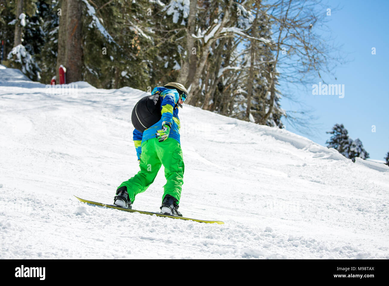 Photo of man riding snowboard from snowy hill Stock Photo - Alamy