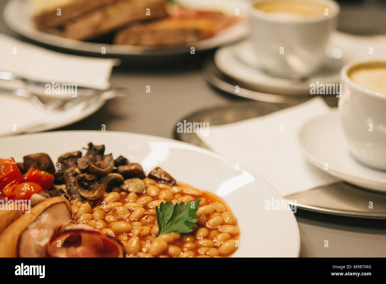 Traditional English breakfast. A cup of coffee with cappuccino is next ...
