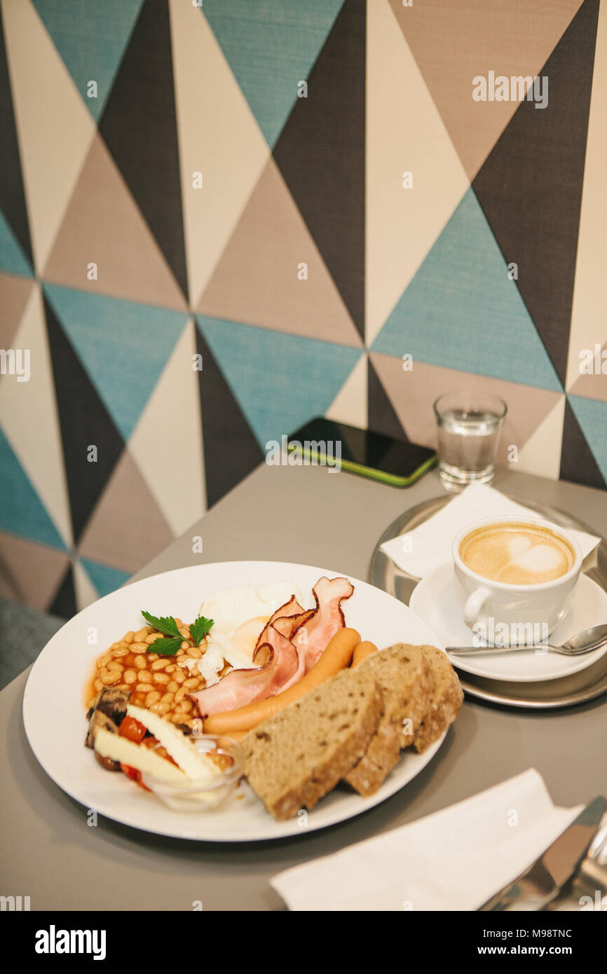 Traditional English breakfast. A cup of coffee with cappuccino is next ...