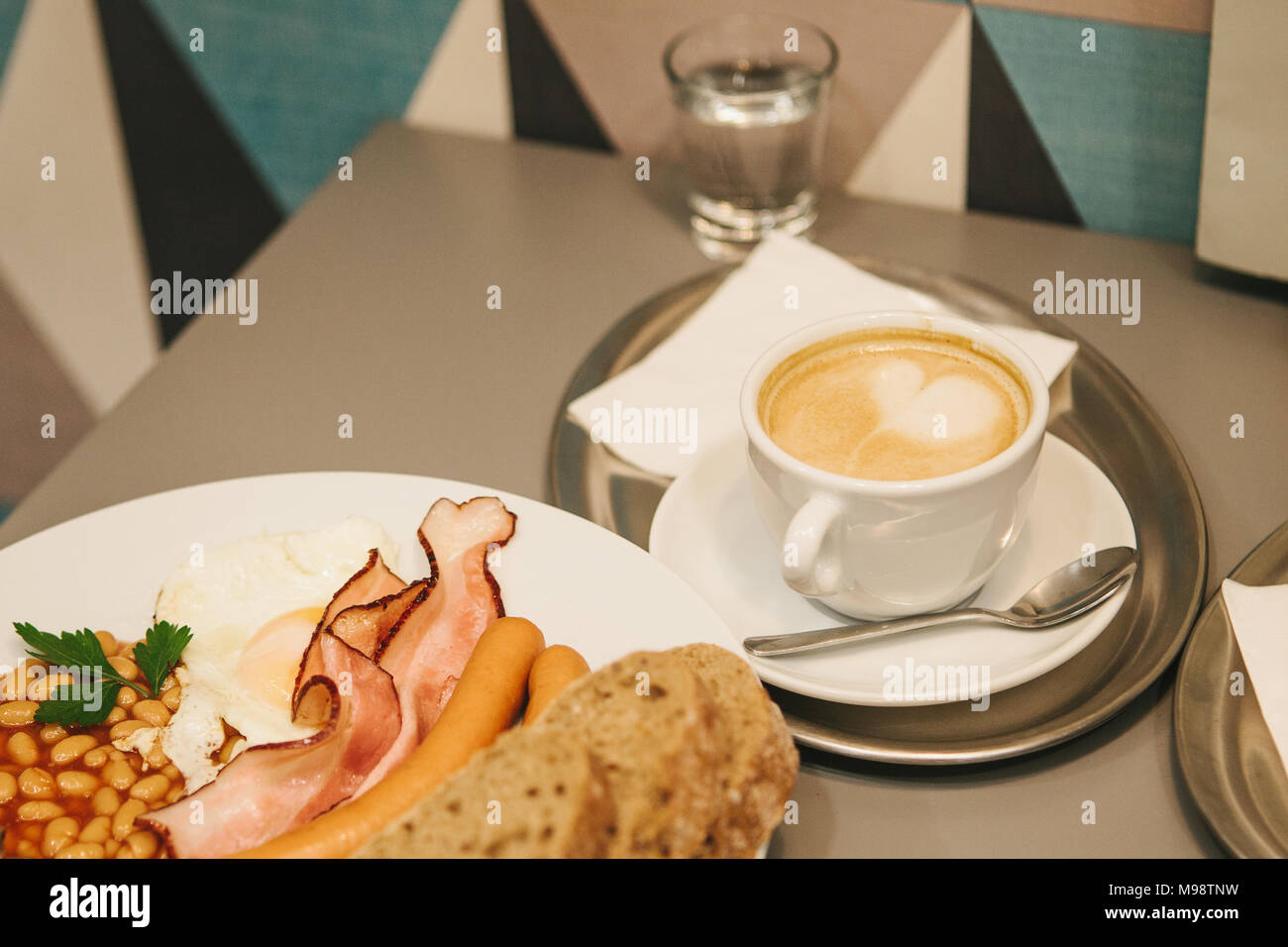 Traditional English breakfast. A cup of coffee with cappuccino is next ...