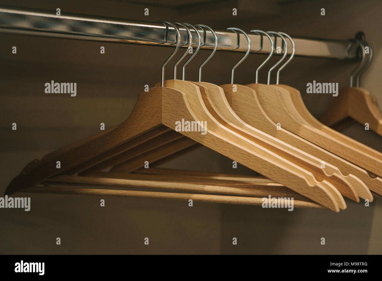 Empty hangers hang in a row in the closet Stock Photo - Alamy