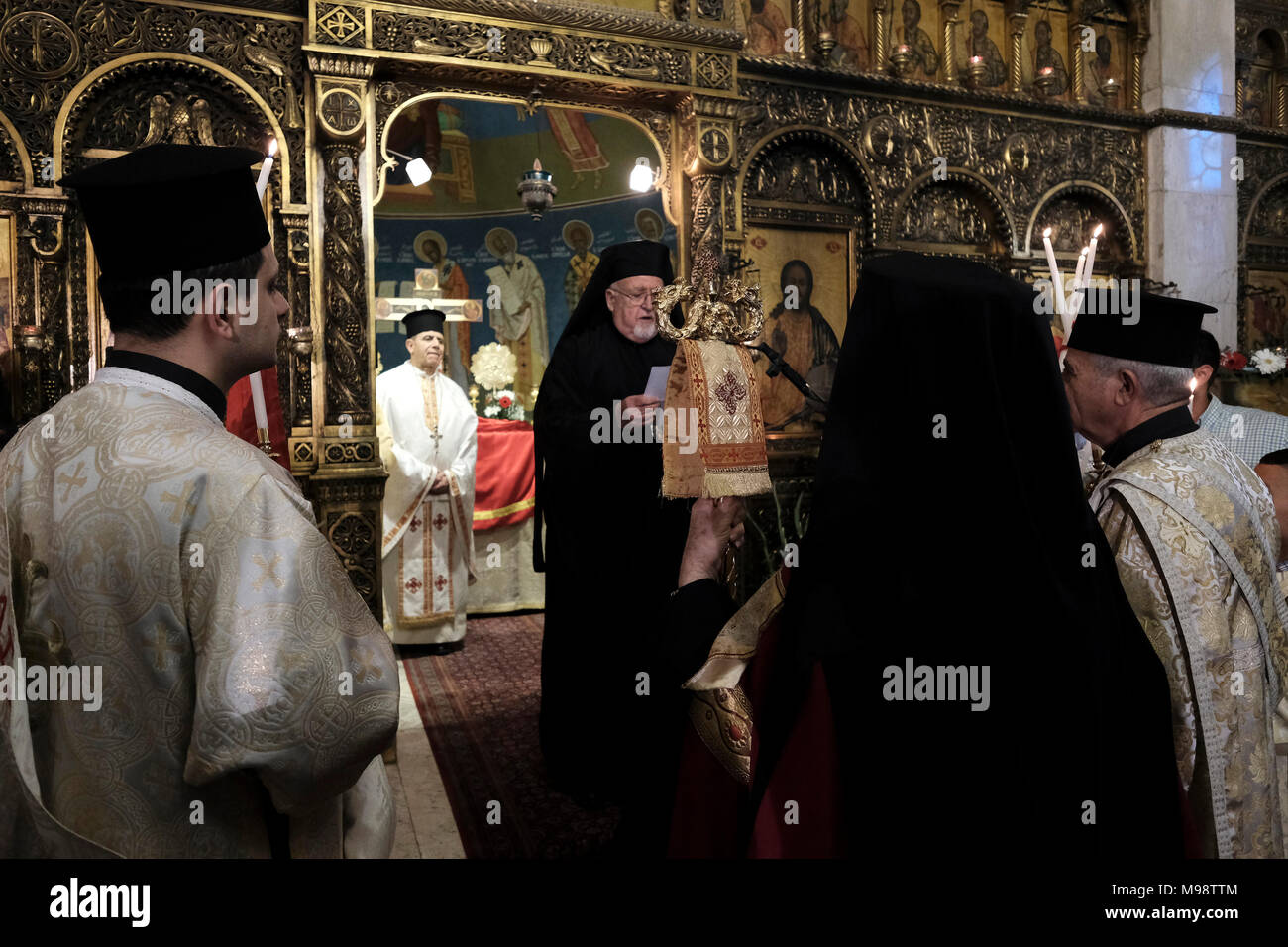 A cleric holds an Eastern-style crosier with serpents representing the ...