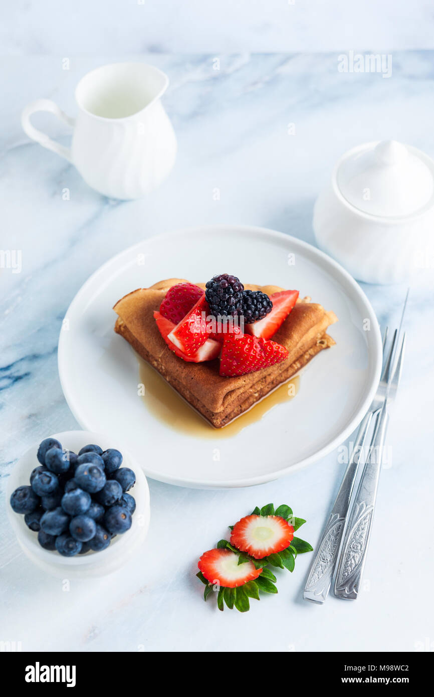Traditional Ukrainian or Russian pancakes with fresh berries and sauce ...