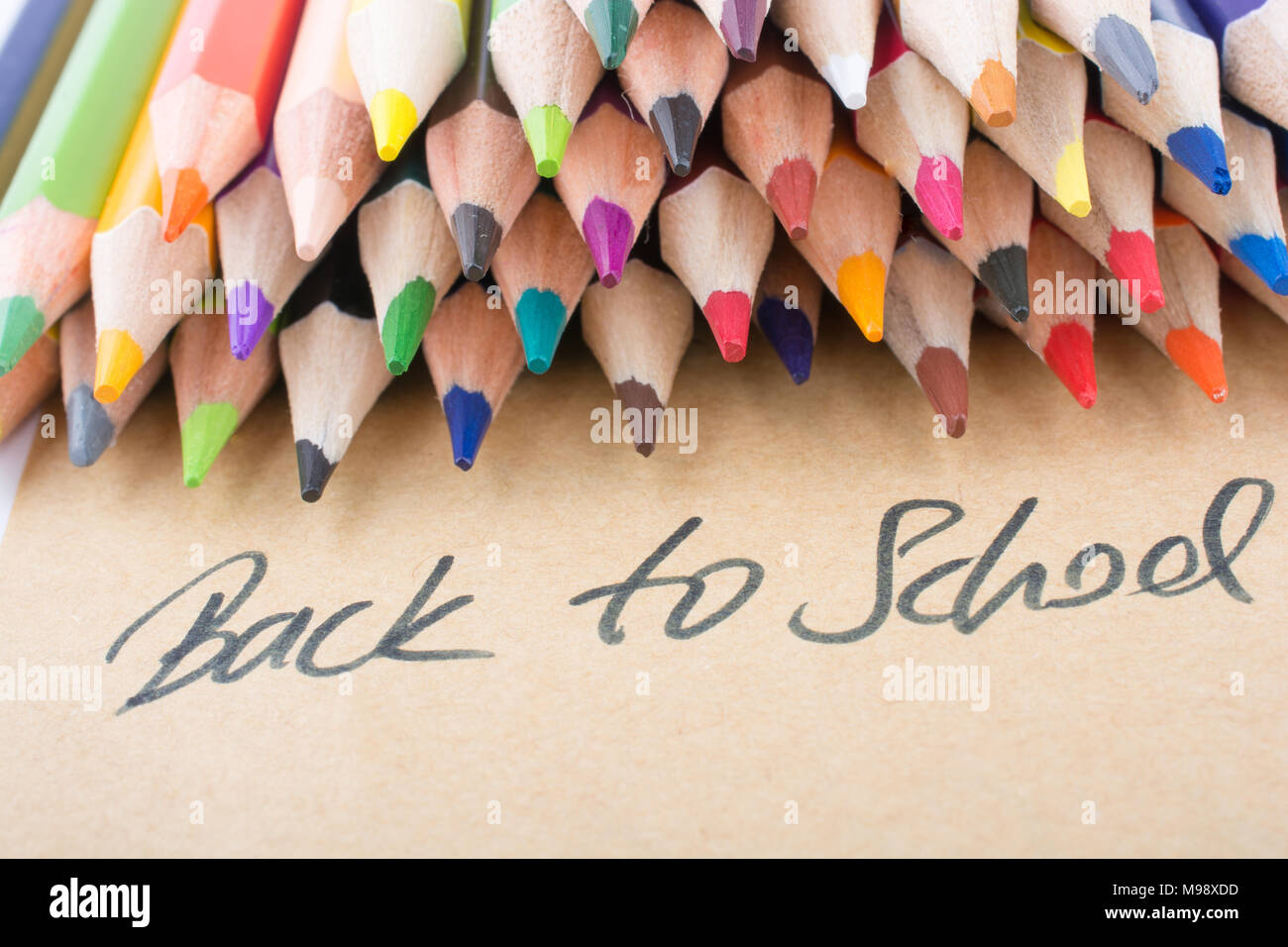 Color pencils and back to school title on a notebook Stock Photo - Alamy