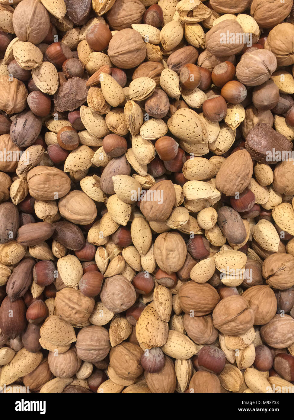 mixed nuts in their shells vertical background Stock Photo - Alamy