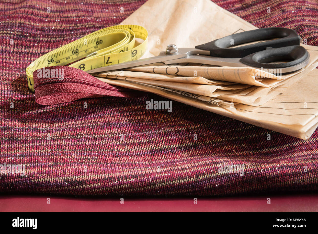 sewing with burgundy fabric side view Stock Photo - Alamy