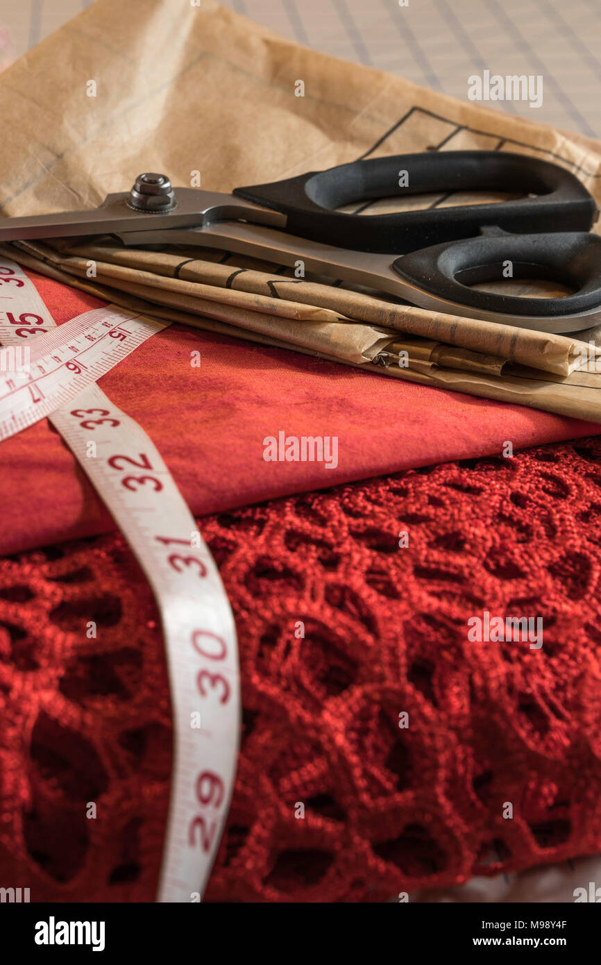 Sewing with red fabrics Stock Photo - Alamy