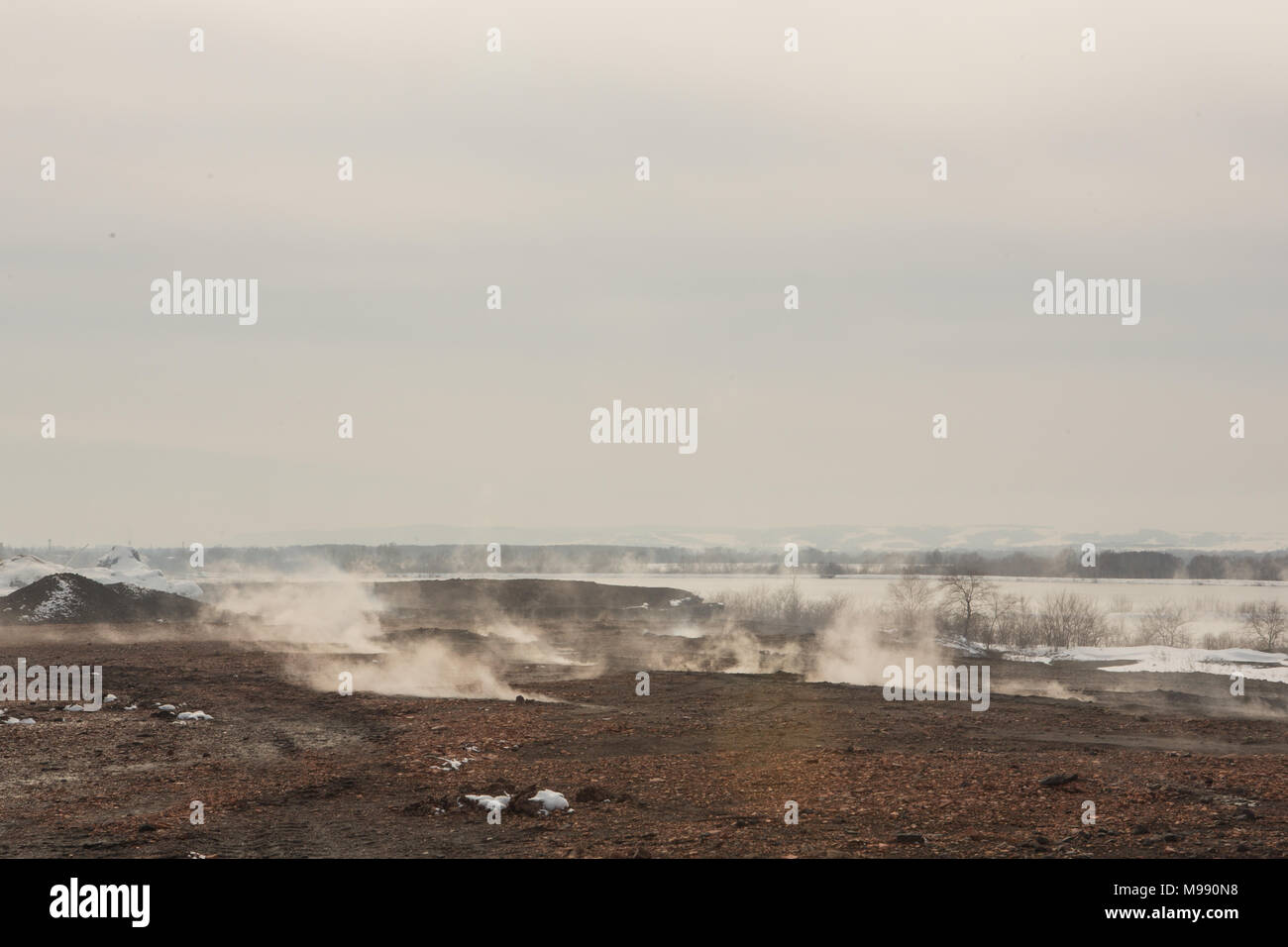 slag dump, smoke on slag dump, pollution Stock Photo - Alamy