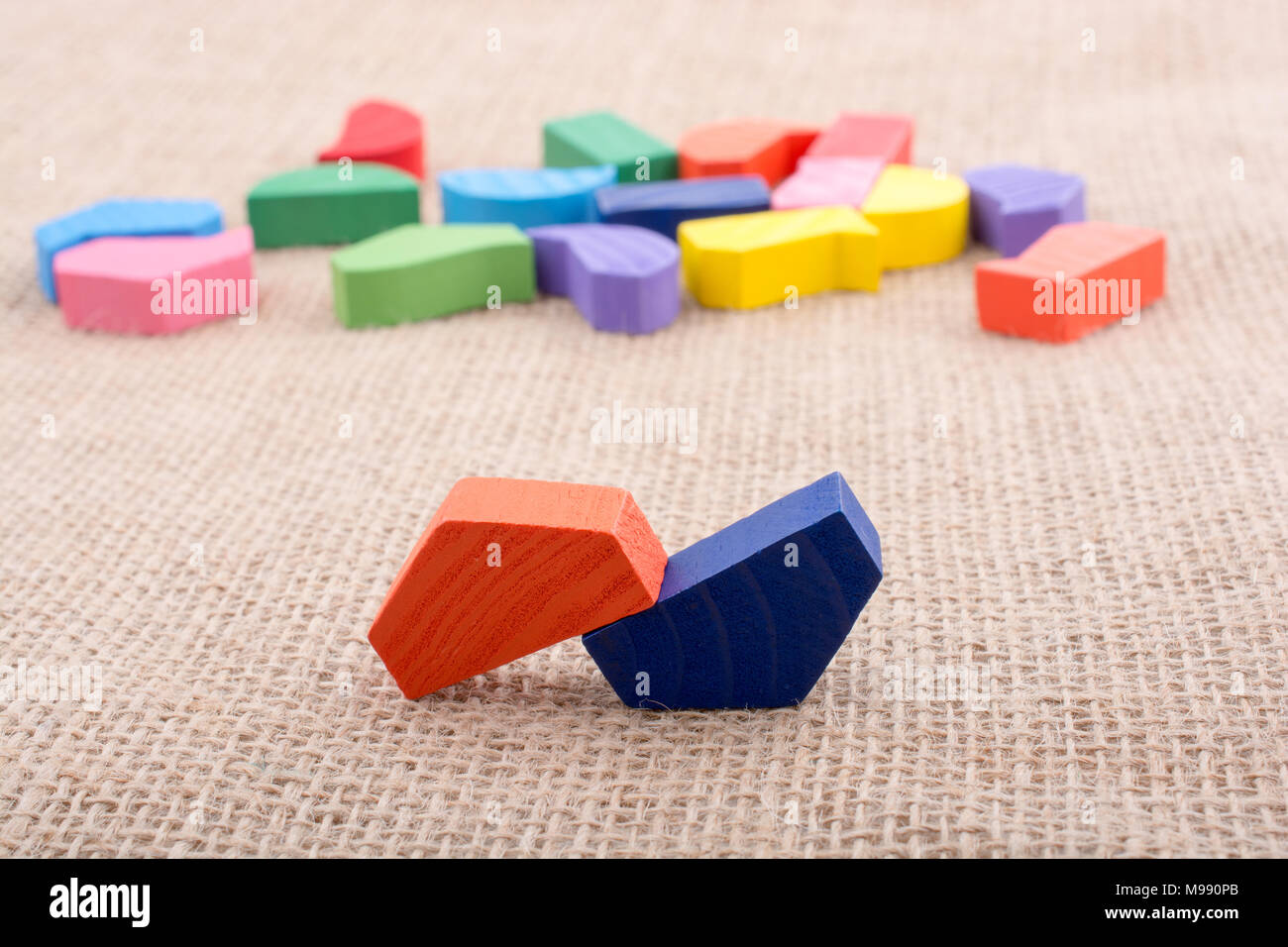 Colorful wooden pieces of a logic puzzle Stock Photo - Alamy
