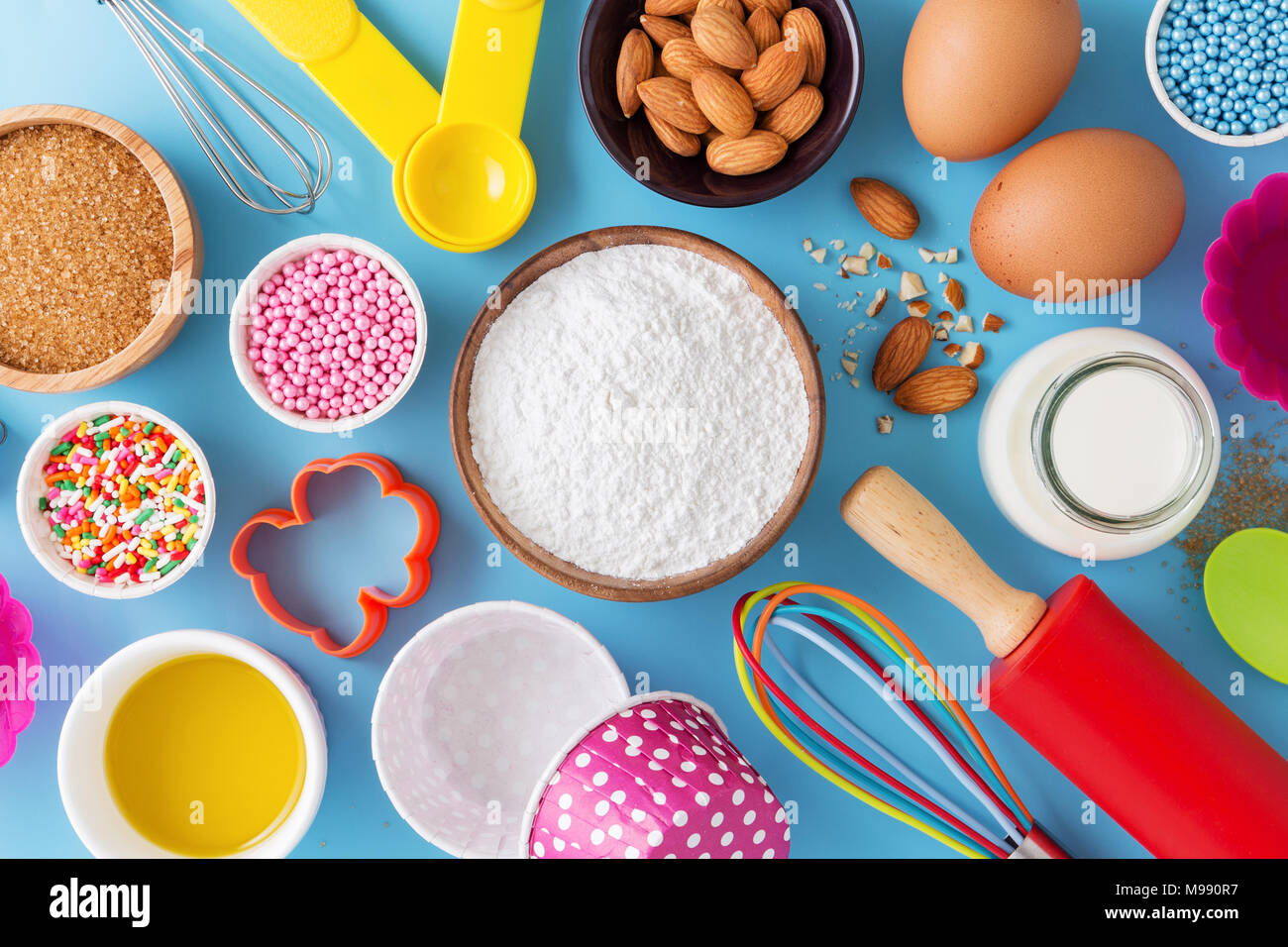 Baking ingredients and utensils on blue background Stock Photo - Alamy