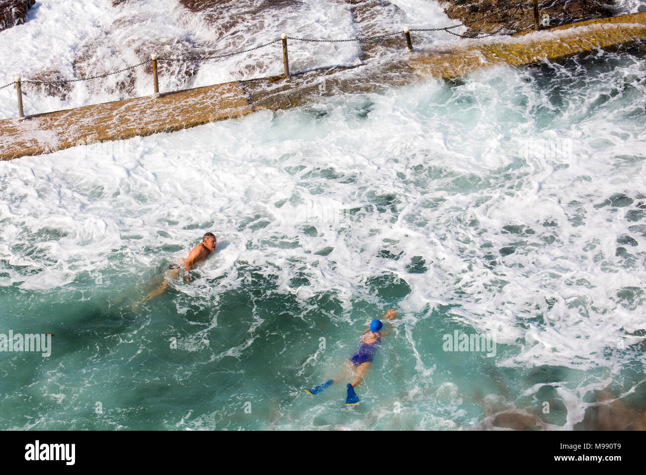 Aerial view of people swimming in the ocean beach rock pool at Avalon ...