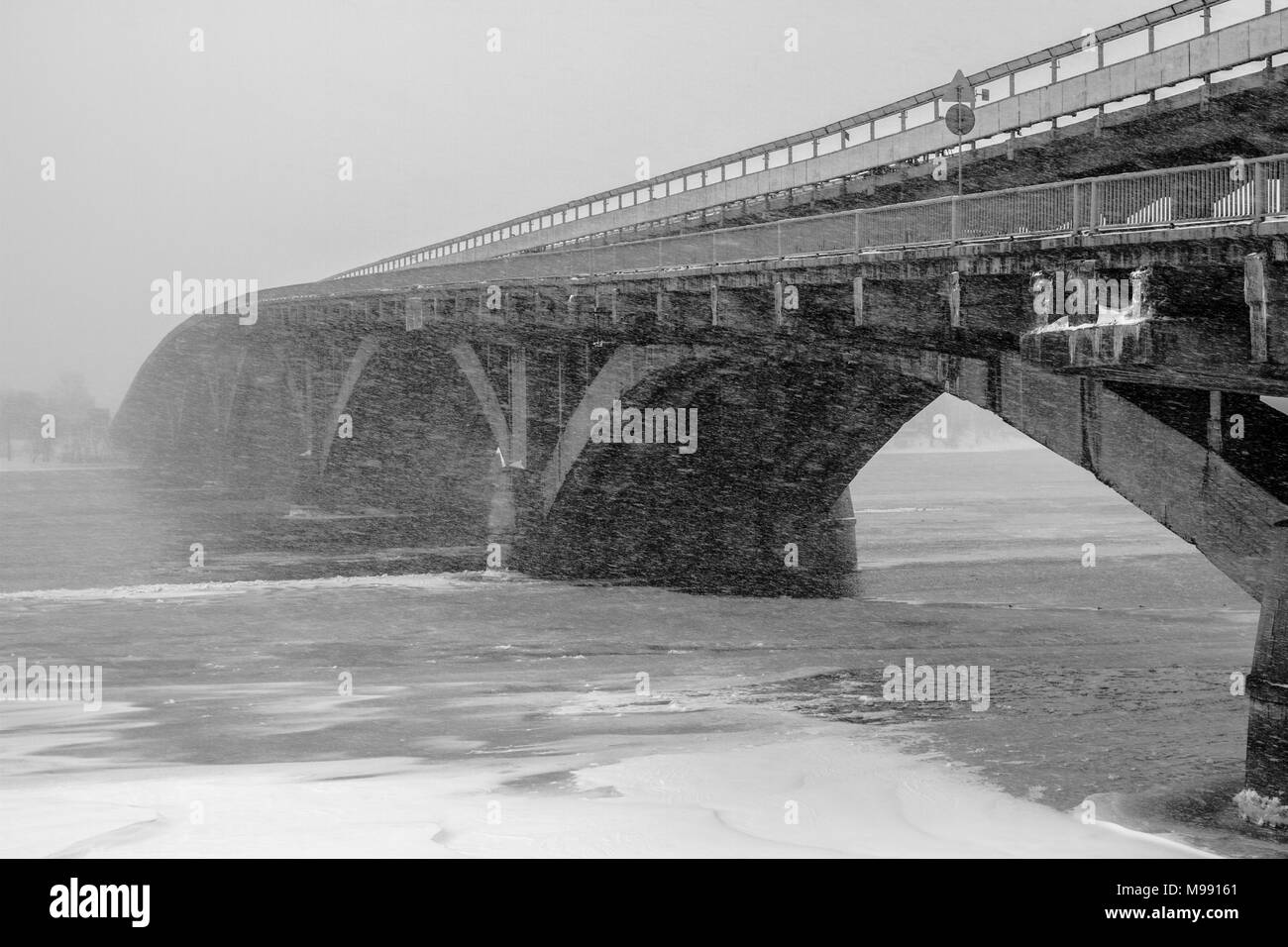 Subway bridge . Winter urban landscape in big snow storm. Poor ...